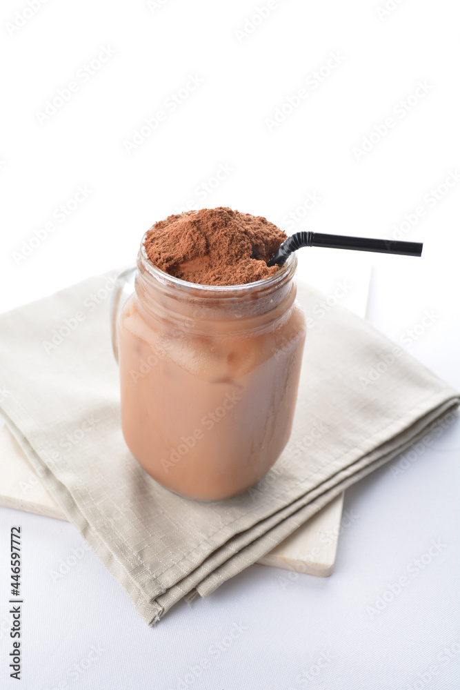 cold iced chocolate milo dinosaur with coco powder in glass jar white ...