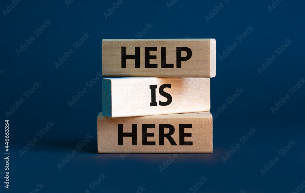 ภาพถ่าย Stock Help is here and support symbol. Wooden blocks with words ...