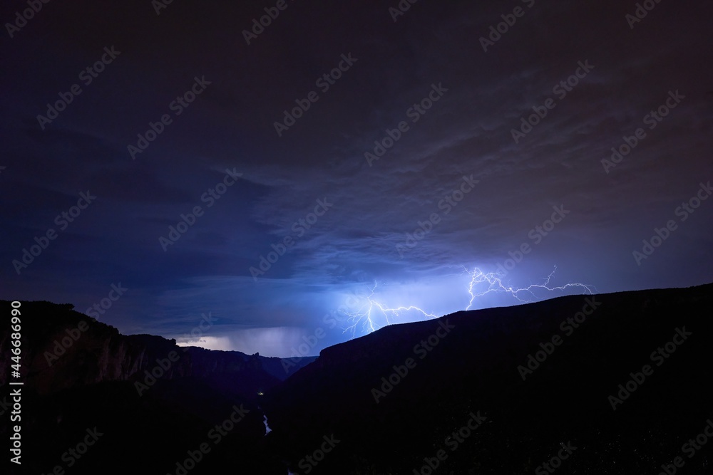 Nocturnal thunderstorm with lightning that makes the river Tarn and the ...