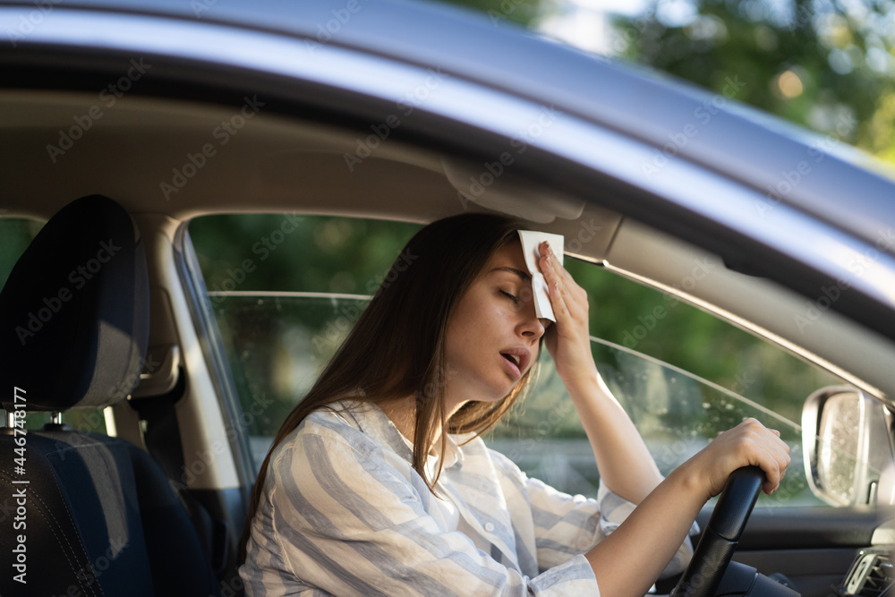 Стоковое фото «Girl driver being hot during heat wave in car, suffering ...