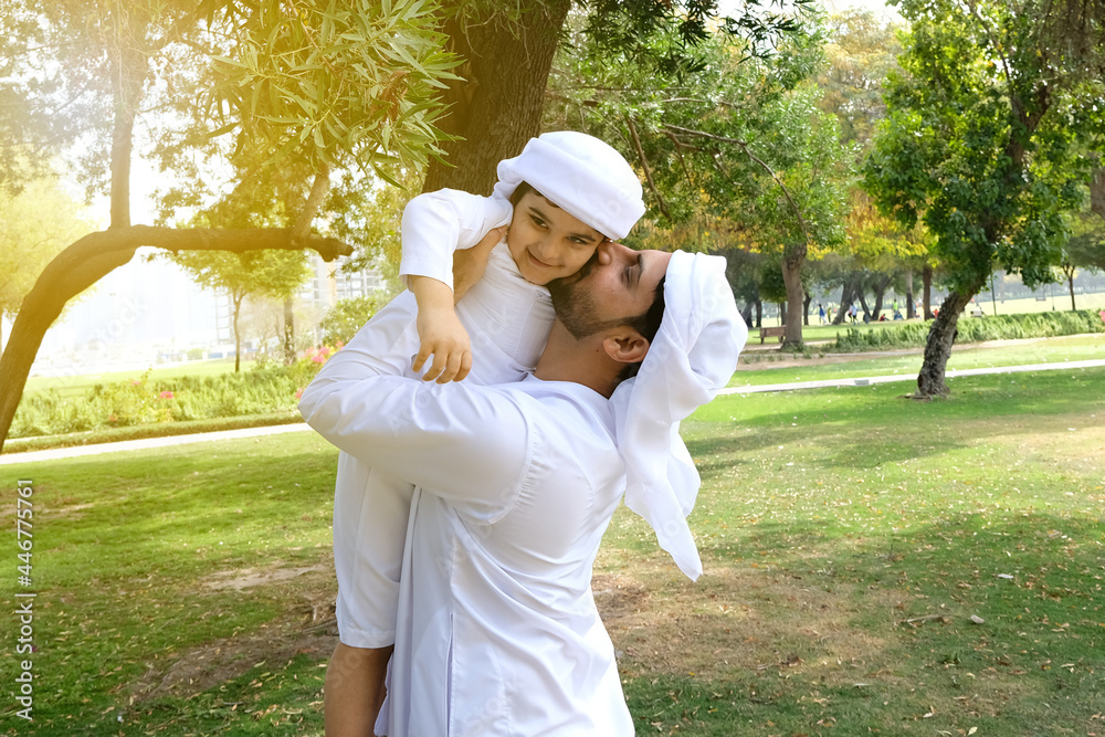 Foto de Stock Arab dad kisses his child as family love affection ...