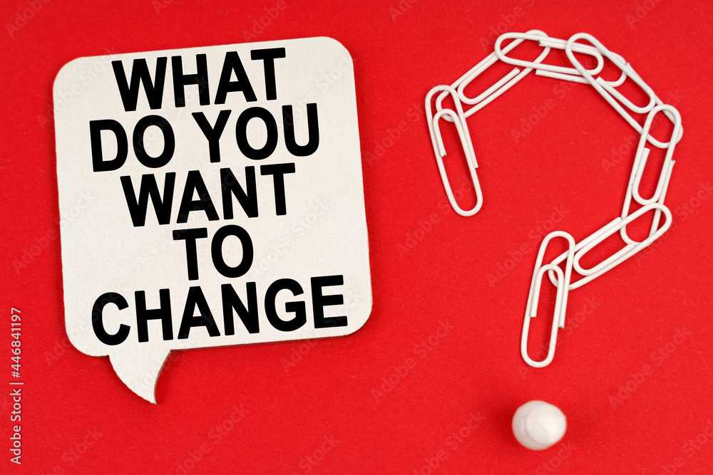 On a red background are a question mark made of paper clips and a sign ...
