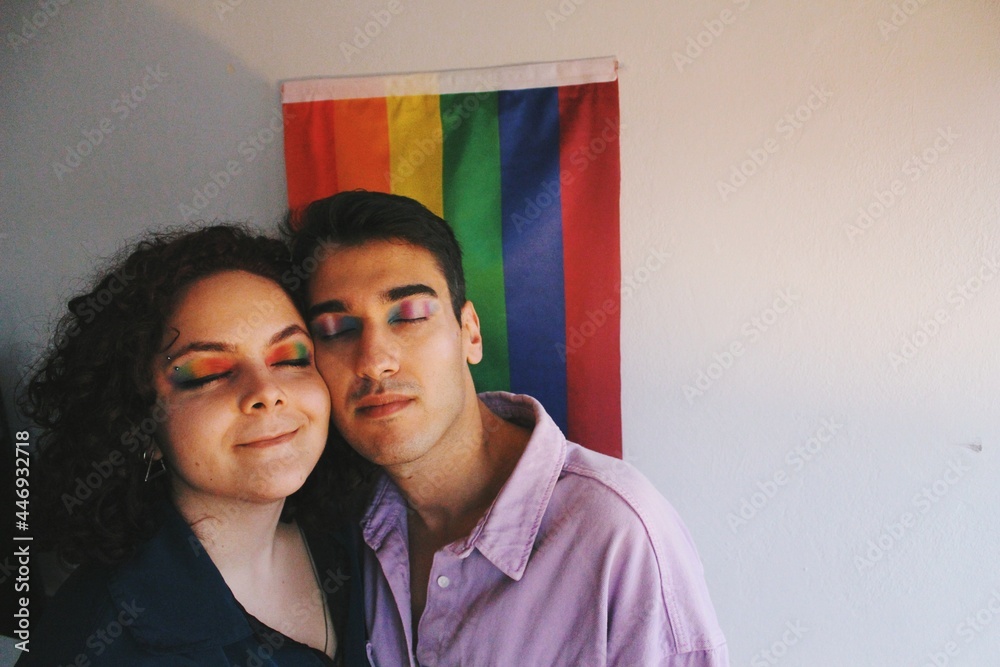 Closeup portrait of queer friends / young couple with lgbtq rainbow ...