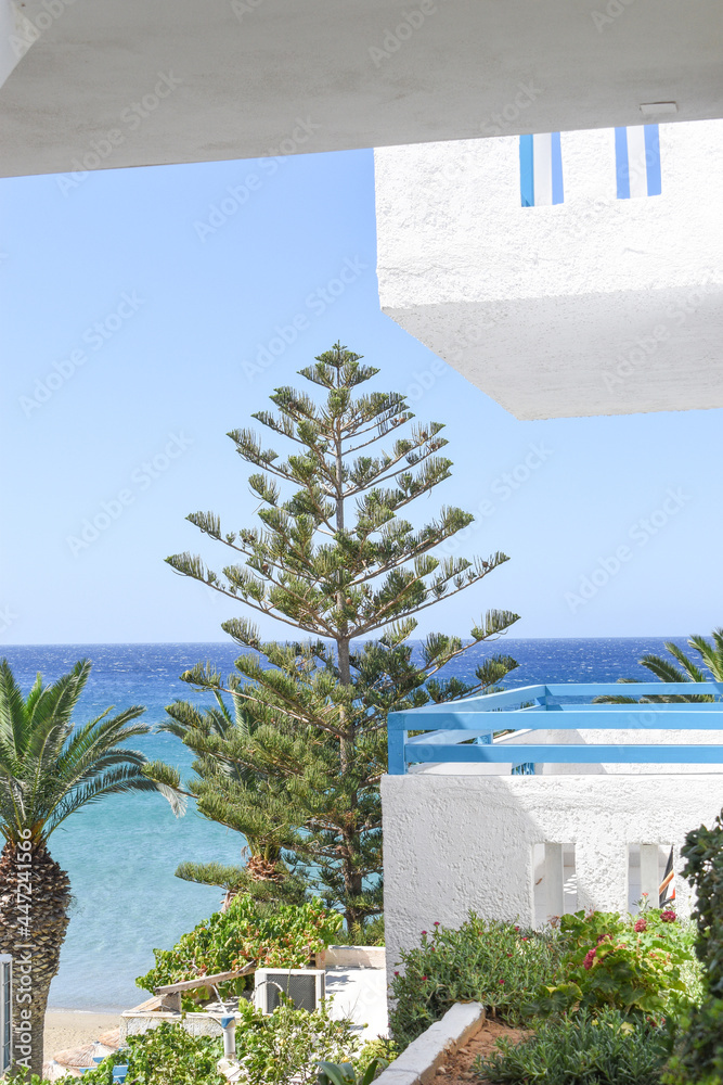 A little window to the Ocean between two Greek buildings. The warm and ...