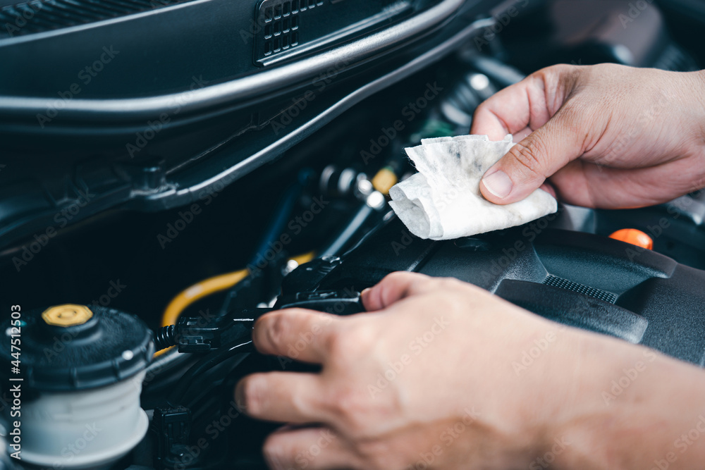 Home service car concept : A man use cloth cleaning Engine oil stain ...