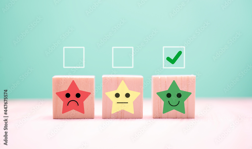 check mark on happy smiley face in wooden block for feedback rating and ...