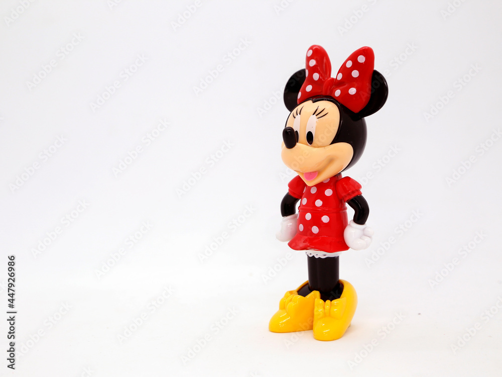 Minnie Mouse in her classic red polka dot dress. Toy. Cartoon character from Walt Disney Pictures Studios. Minnie is Mickey Mouse s girlfriend. Plastic doll. Daisy duck s friend. Isolated white. Stock...