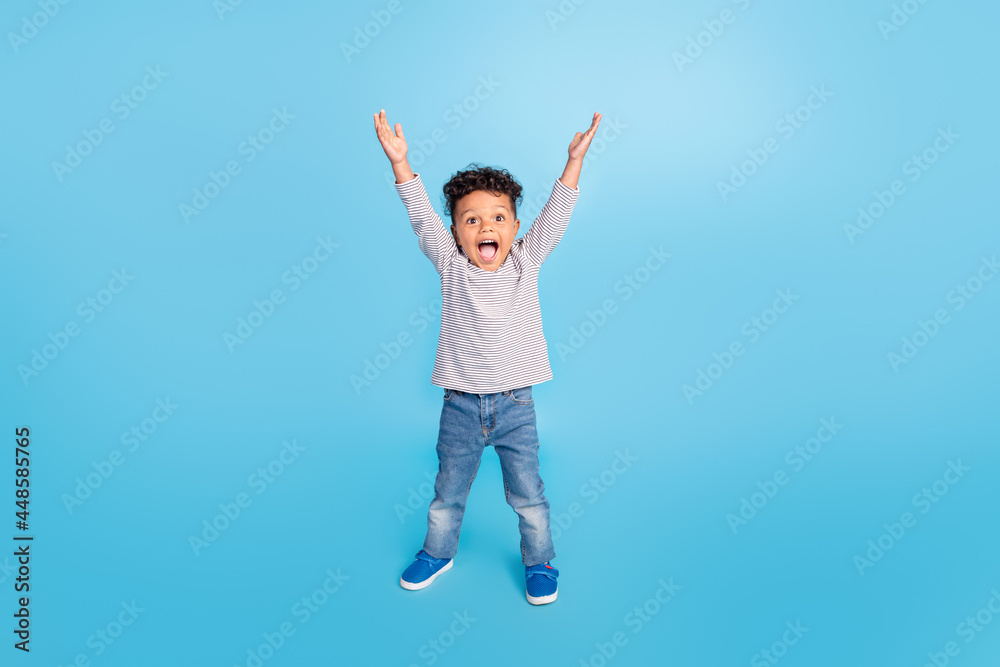 Full length body size view of attractive cheerful boy rising hands up ...
