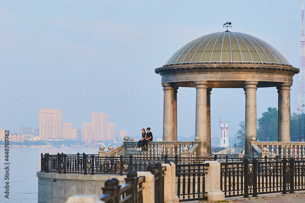 Rotunda with a weather vane on the river embankment. TV tower ...