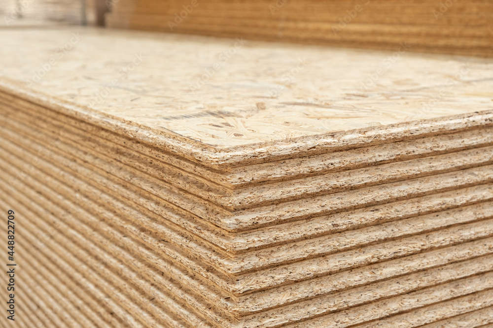 The stack of OSB sheets are stacked in a hardware store on a pallet ...
