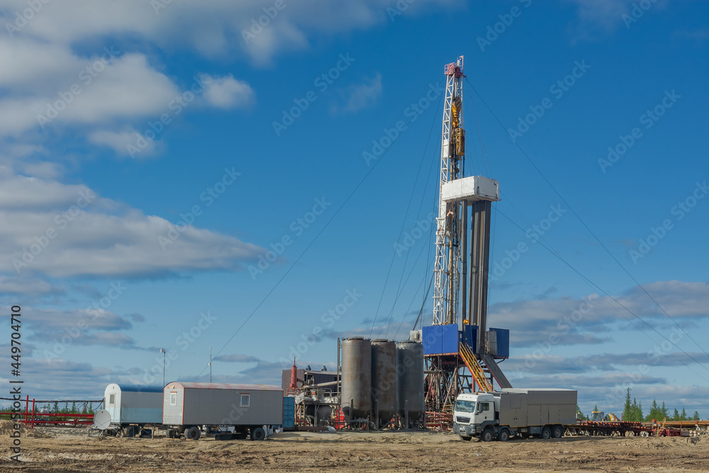The drilling rig is included in the landscape of the oil and gas field ...