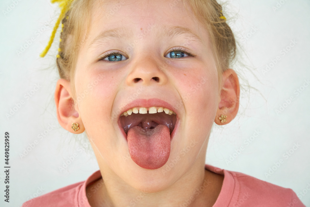 Cheerful child. Girl laughs close-up of the face on a white background ...