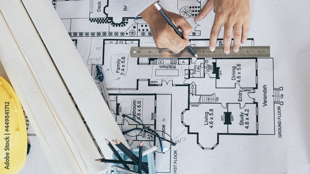 Engineer and Architect concept, Man uses a ruler to measure the floor ...