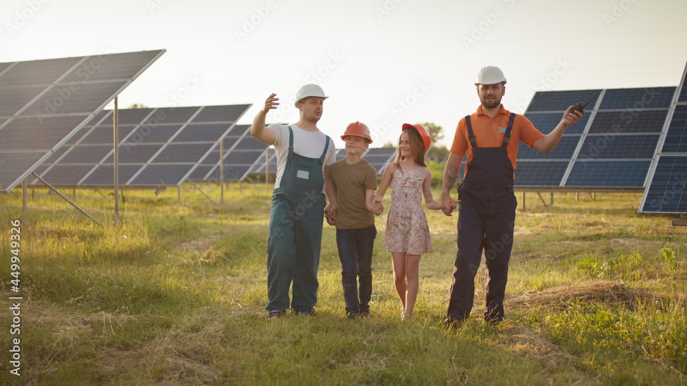 Two parents brought their children to work. Two employees of a solar ...