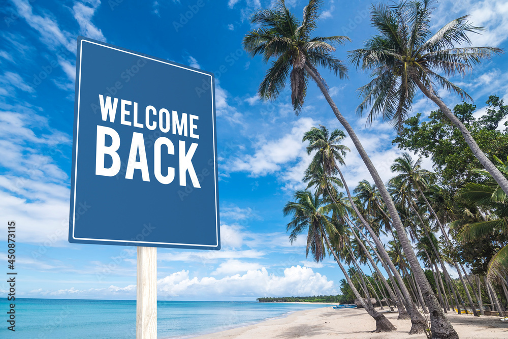 A welcome back sign in front of a tropical beach resort, welcoming back ...
