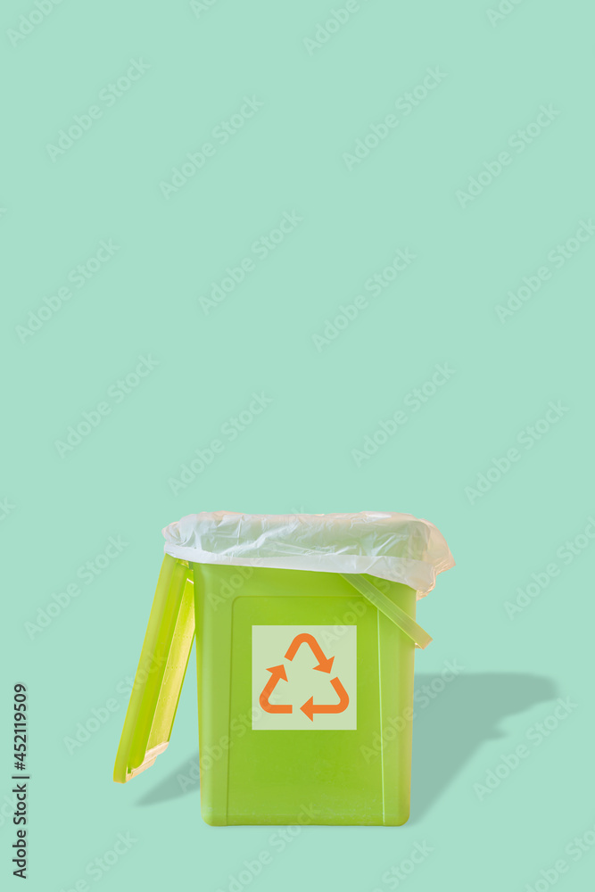 Cover page with a empty green garbage trash bin with bag inside and ...