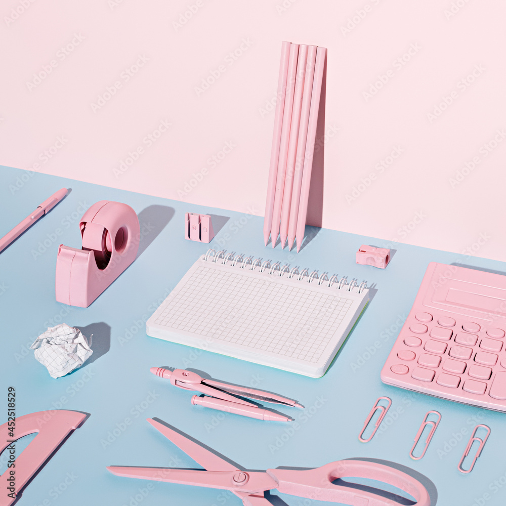 Creative office and school equipment painted in pastel pink color ...