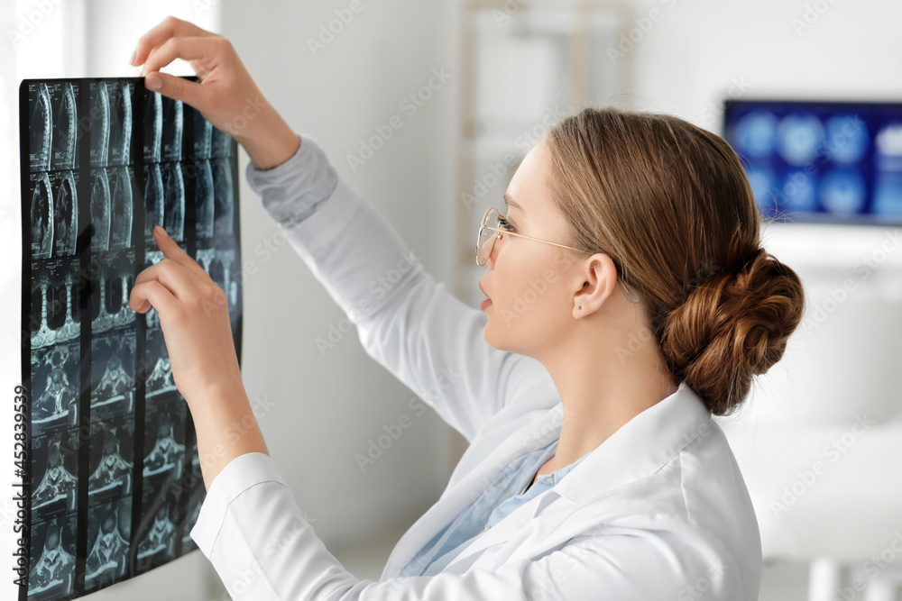 Female doctor with x-ray scan in clinic Stock Photo | Adobe Stock