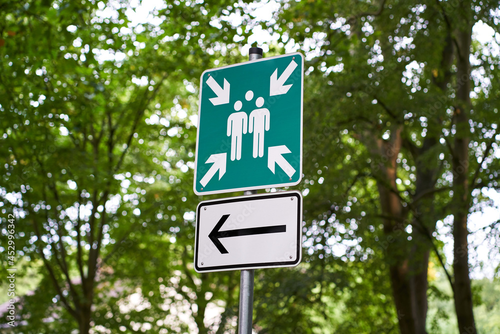 Assembly point sign with directional arrow. Stock Photo | Adobe Stock