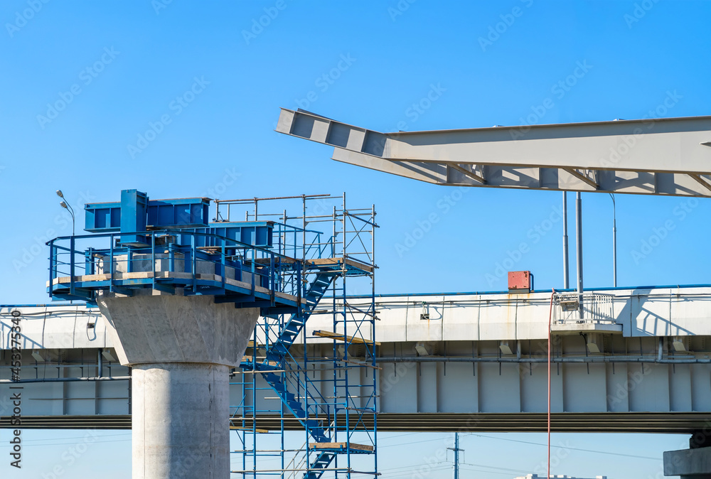 New highway bridge under construction. Connection of steel powerful ...