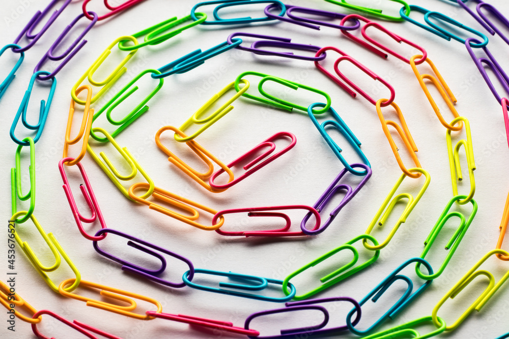 Spiral made of linked colored paper clips. Rainbow colors, selective ...