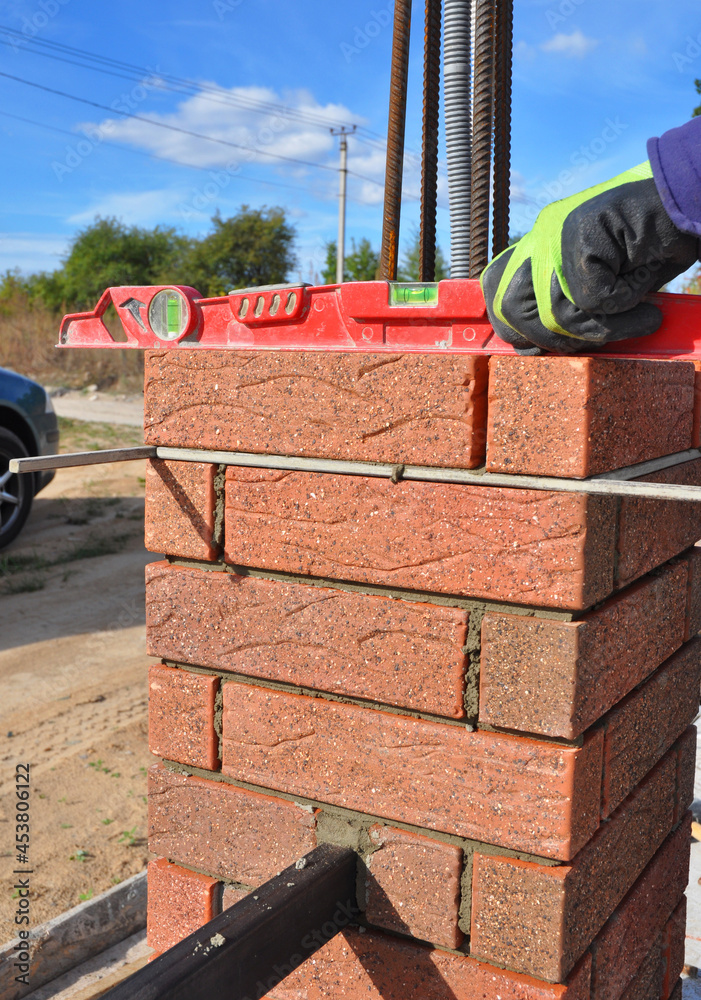 Brick fence pillar, column construction with steel rebars and vertical ...