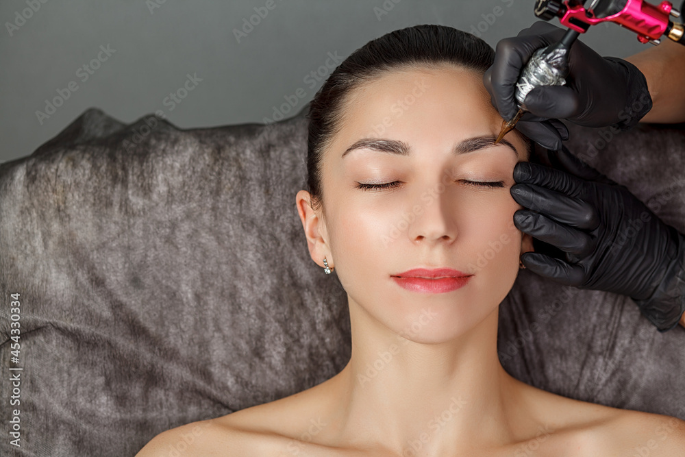 Permanent make up procedure, applying on young girl. Beautiful woman ...