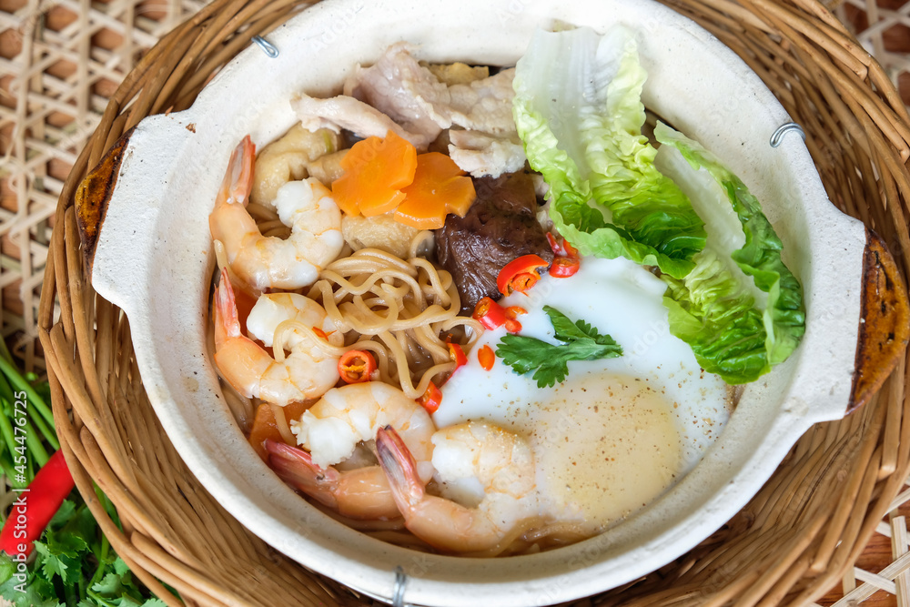 Homemade Chinese cuisine. Claypot Yee Mee Noodle Soup. Broth made from ...