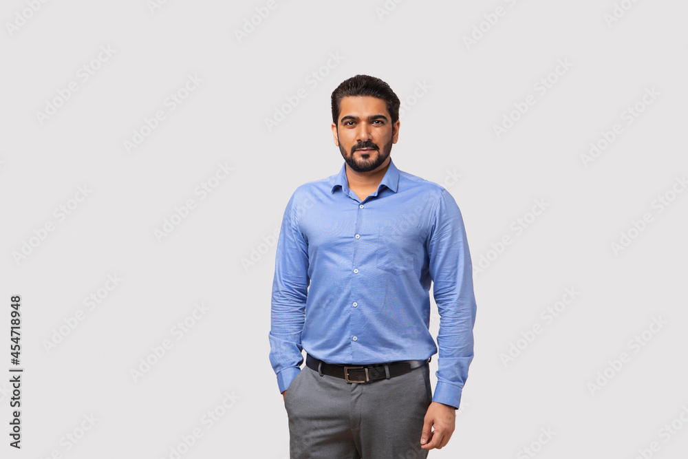 Portrait of man standing in formal clothing smiling against white ...