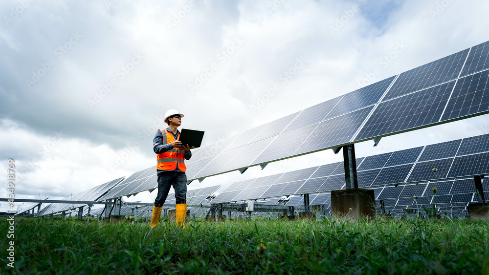 The solar farm(solar panel) with engineers check the operation of the ...