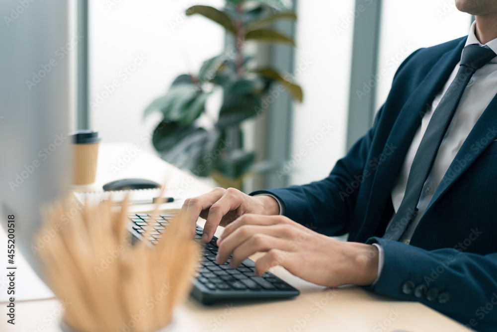 Adult smart business man in suit outfit sitting and working in front of ...