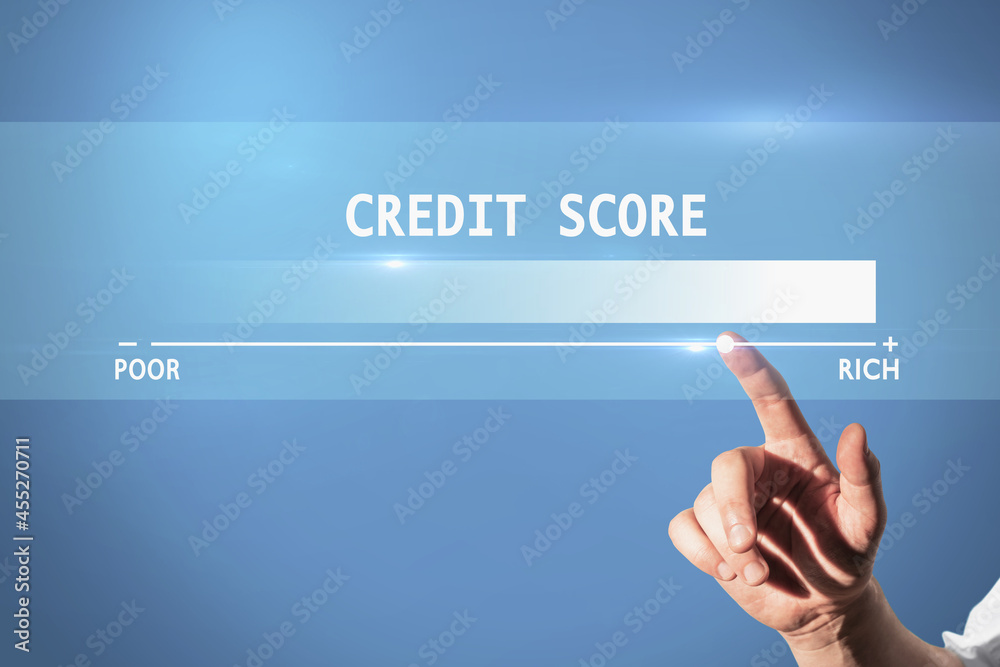 Businessman hand pointing at blue background with credit score scale ...