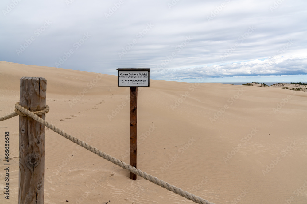 fence post and rope with a a no trespassing sign in the pristine sand ...