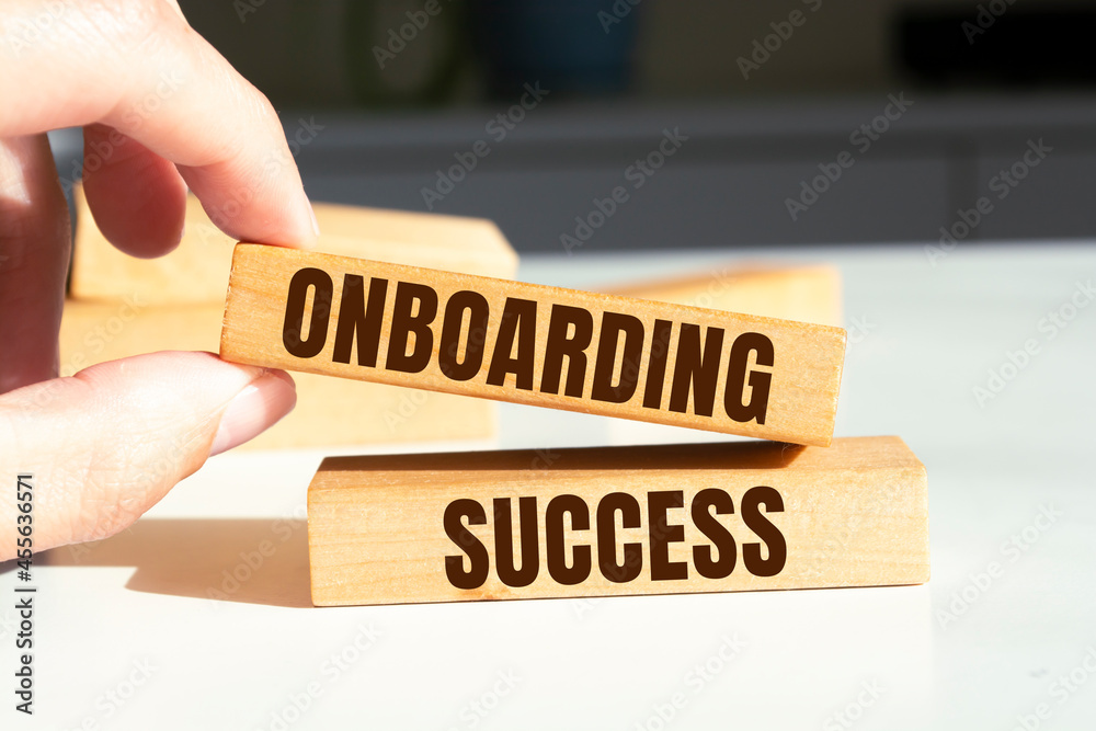 Onboarding success symbol. Wooden blocks with words 'Onboarding success ...
