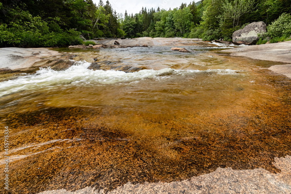 Water of Nesowadnehunk stream flows over the rocks of Ledge Falls in ...