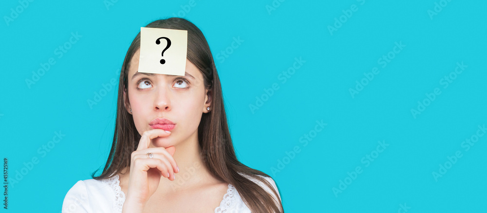 Confused female thinking with question mark on sticky note on forehead ...
