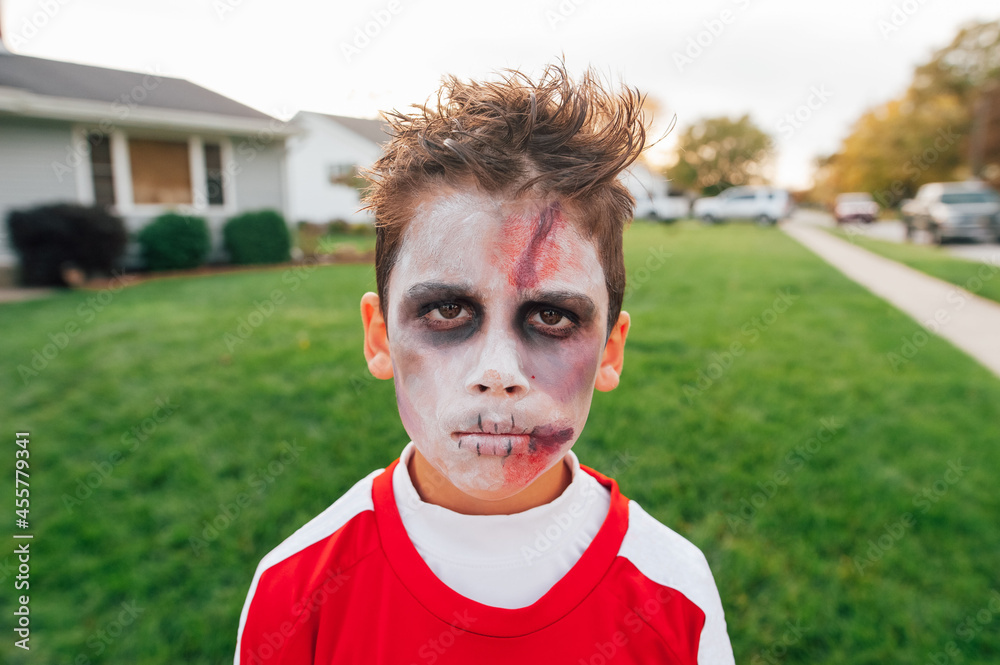 Preteen child face painted as a zombie. Stock Photo | Adobe Stock