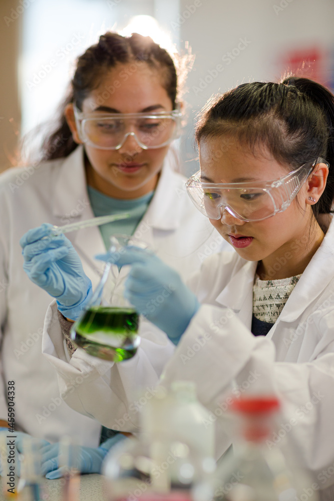 Students watching chemical reaction, conducting scientific experiment ...