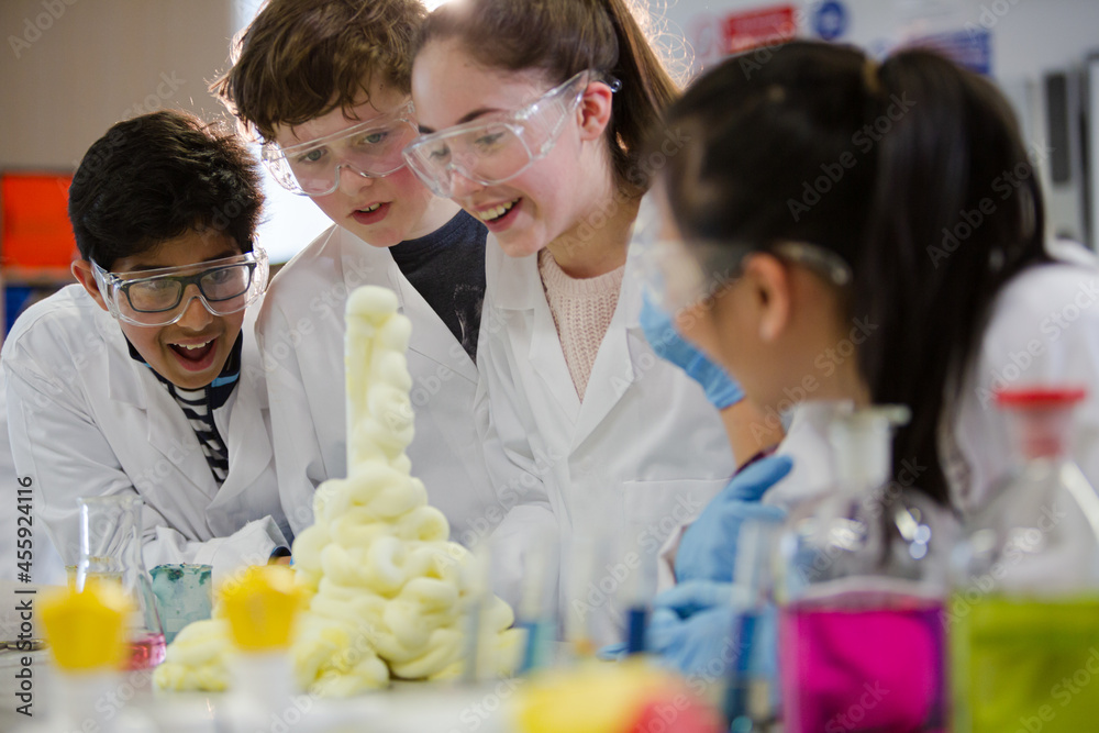 Surprised students conducting scientific experiment, watching chemical ...