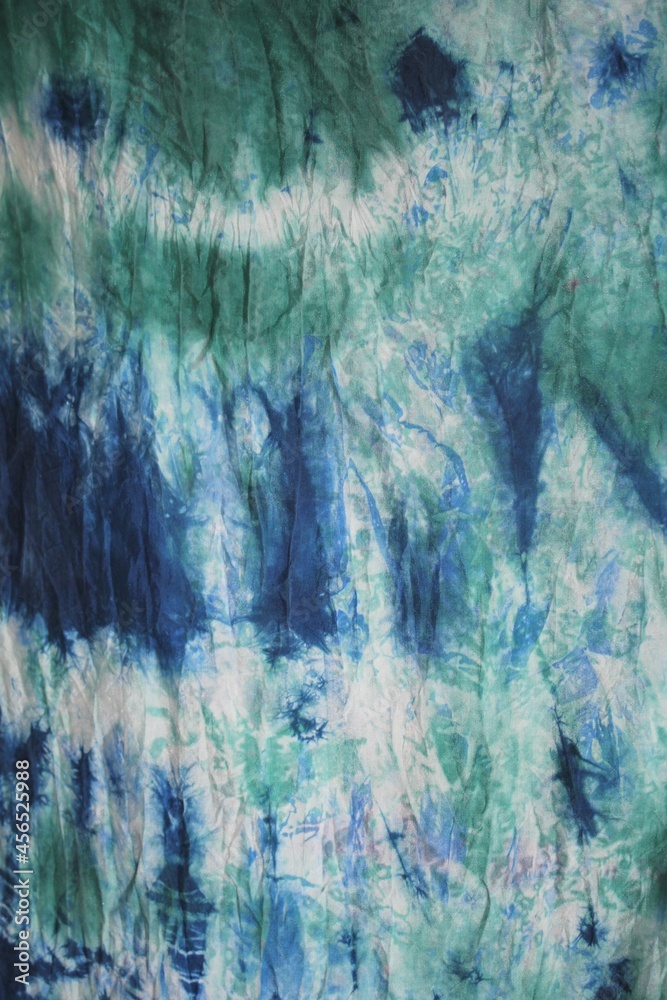 Tie dye green background with half circle layers of dye pattern fading ...