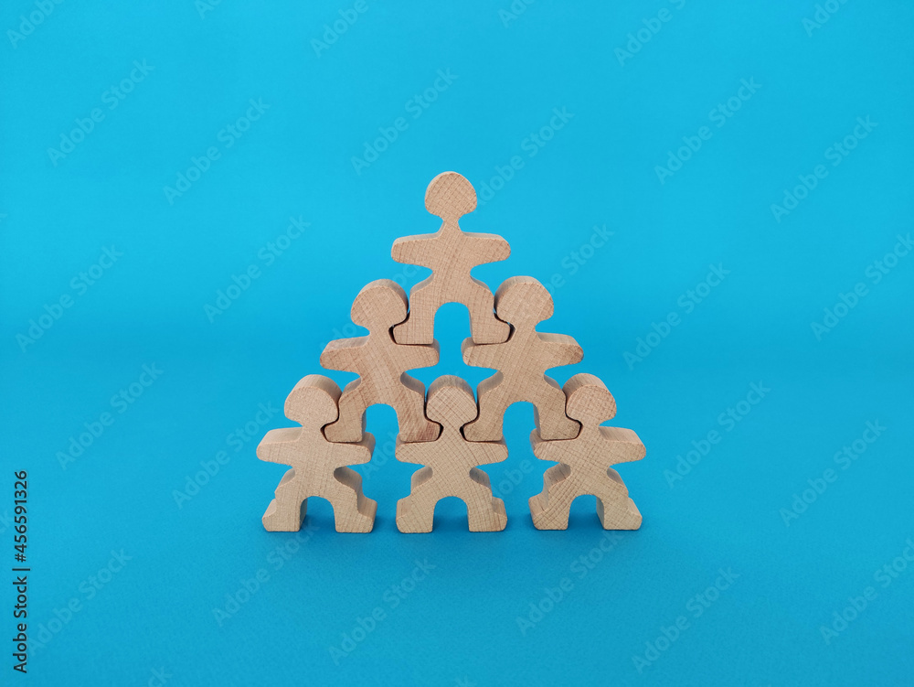 Teamwork and cooperation concept, wooden people standing shoulder to ...
