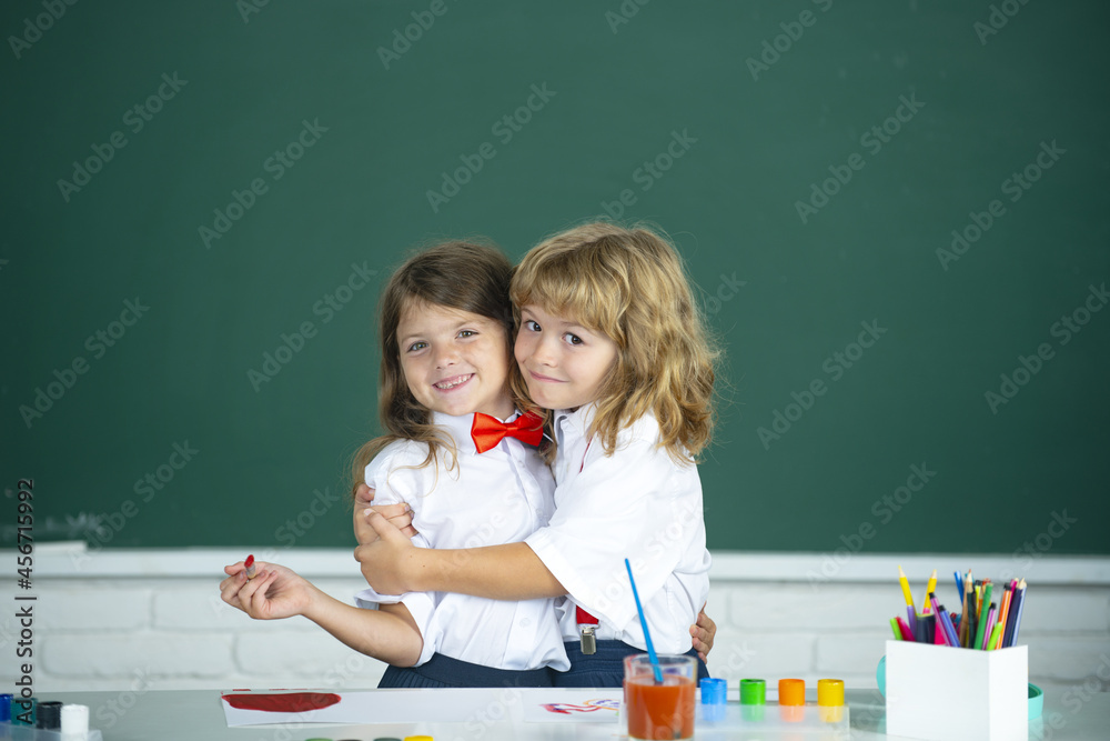 School friends hugging. Two school kids, girl and boy holding hands ...