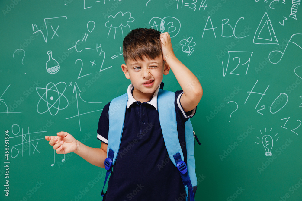 Young puzzled questioned male kid school boy 5-6 years old wear t-shirt ...