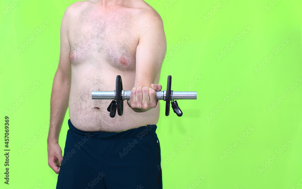 Front view of a middle-aged dad bod man in his 30s lifting a dumbbell ...