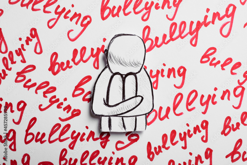 Child paper figure and words Bullying written on white background, top ...