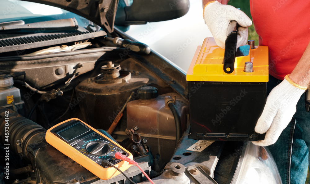 Car maintenance before winter. An auto mechanic is changing the car ...