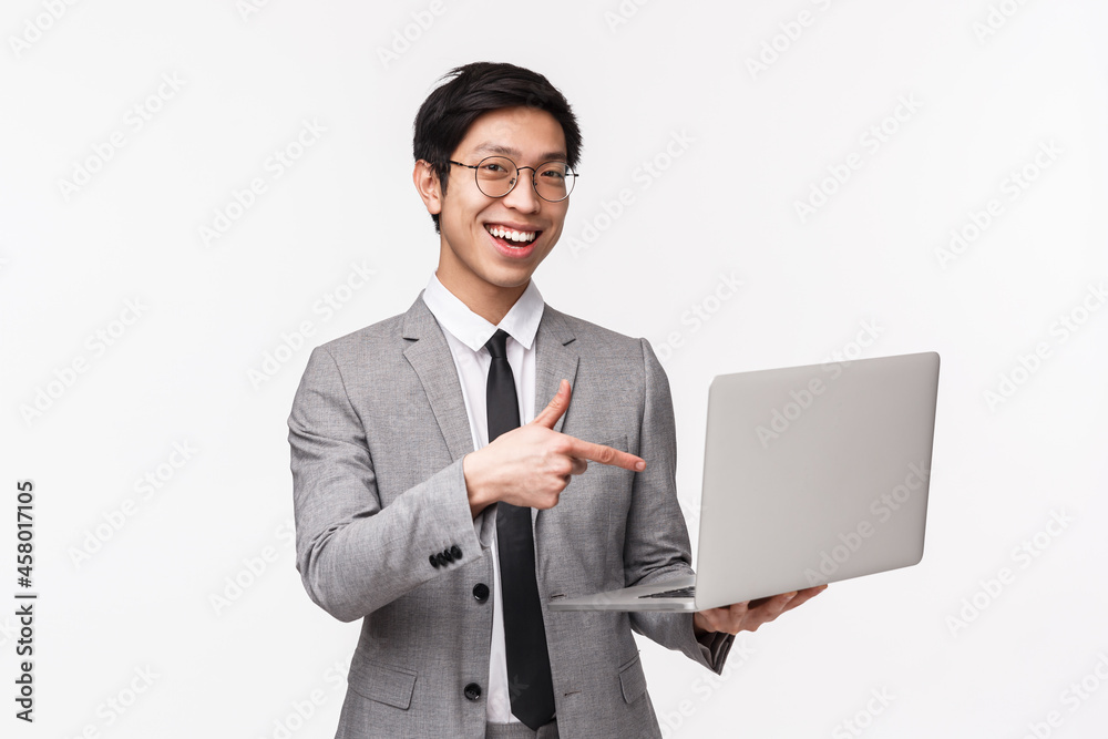 Waist-up portrait of successful pleased young asian businessman ...
