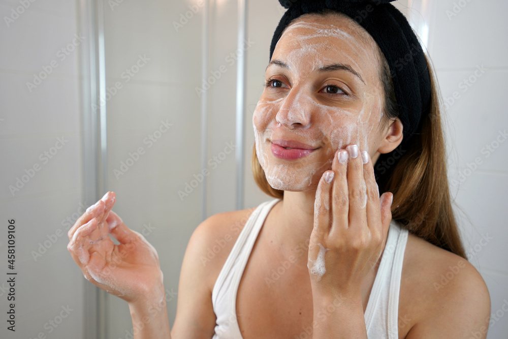 Young Skin Care Routine. Girl washing face foaming soap scrubbing skin. Face wash exfoliation ...