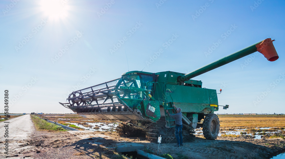 Mature Farmer Getting Off the Combine Harvester Parked On The Side Of ...