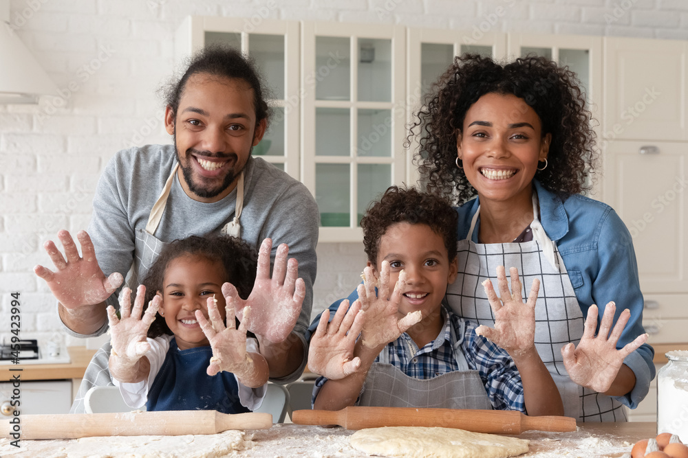 Head shot portrait happy African American family cooking baking ...